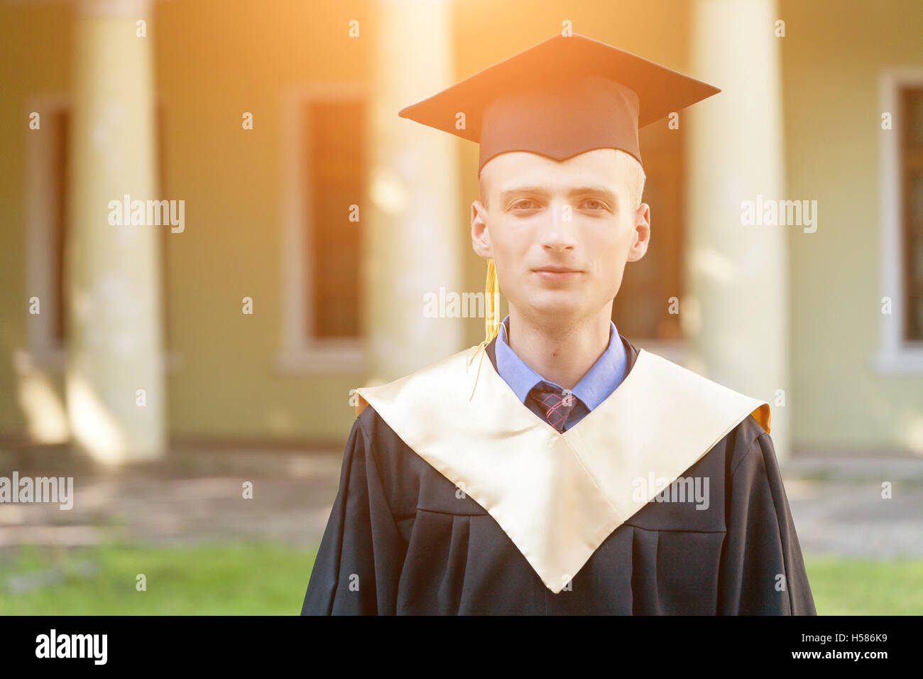 Graduate students wearing graduation hat and gown, outdoors Stock Photo ...