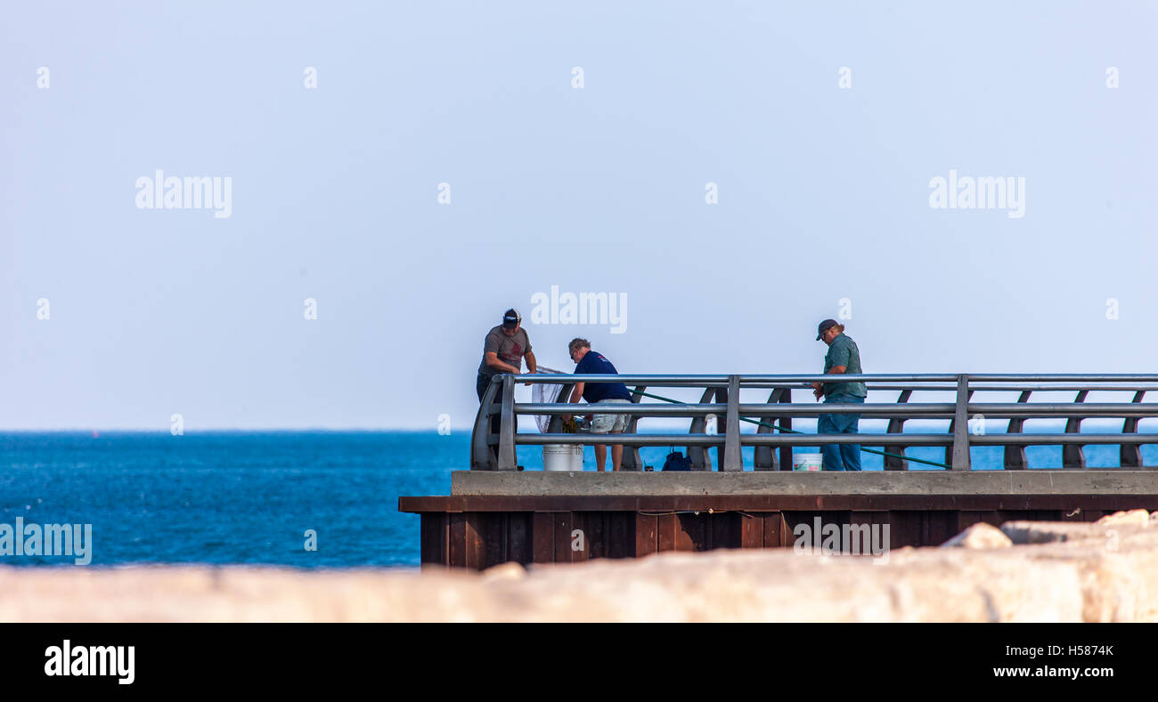 Three men fish the St. Clair River from under the Bluewater Bridge in ...