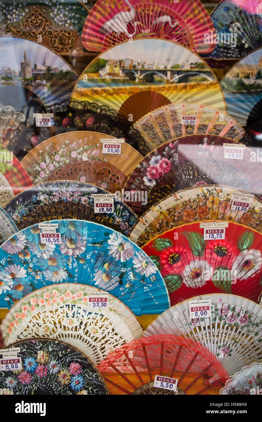 A selection of colourful fans in the window of a shop in Seville, Spain ...