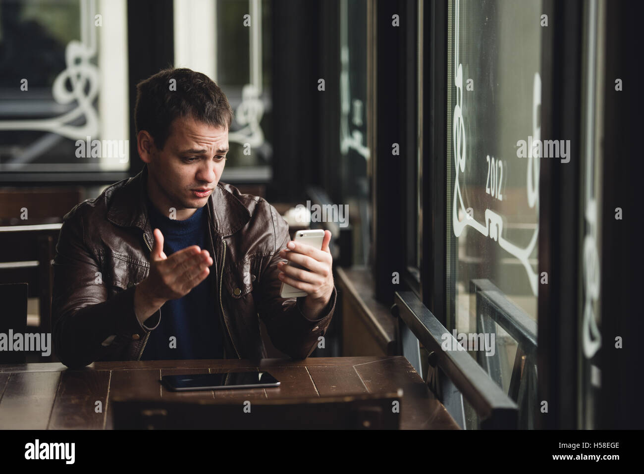 Young man making a video call from his mobile phone. Selective focus ...
