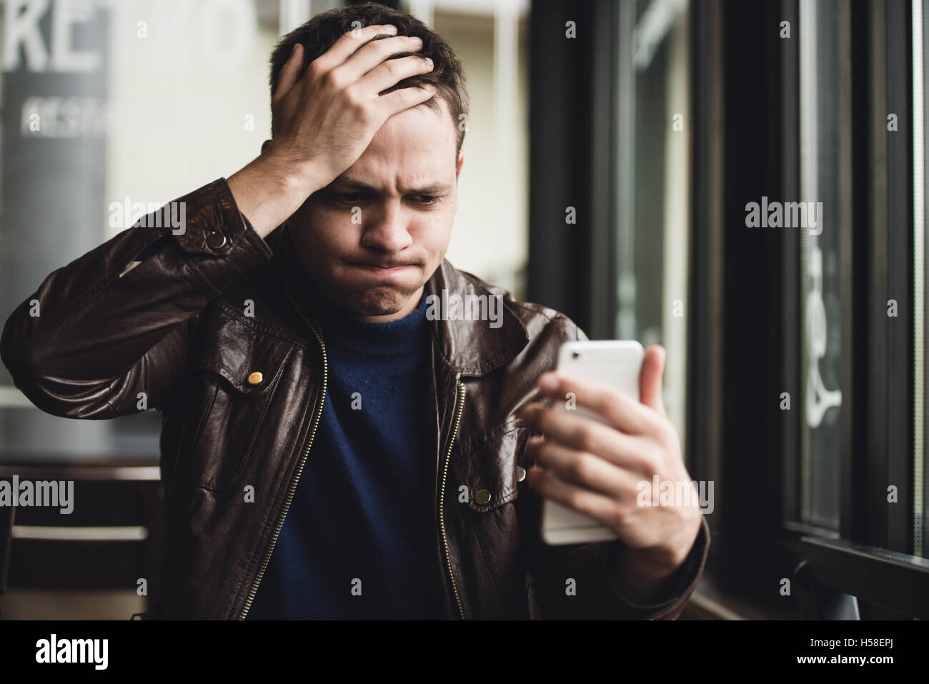 Closeup portrait, stressed young man in purple sweater, shocked ...