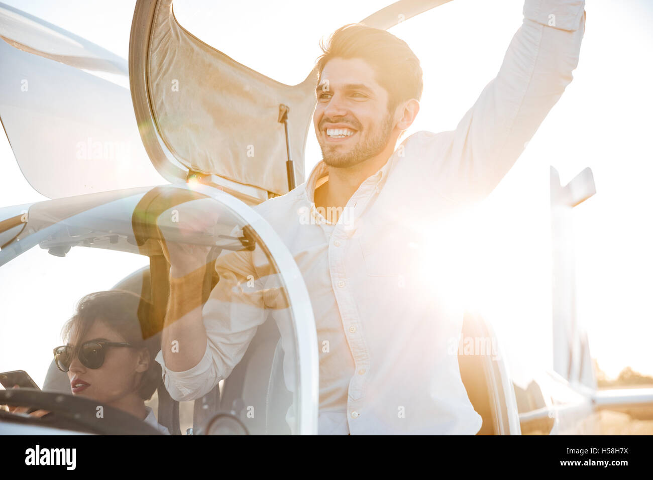 Cheerful young man pilot getting out of the plane after landing Stock ...