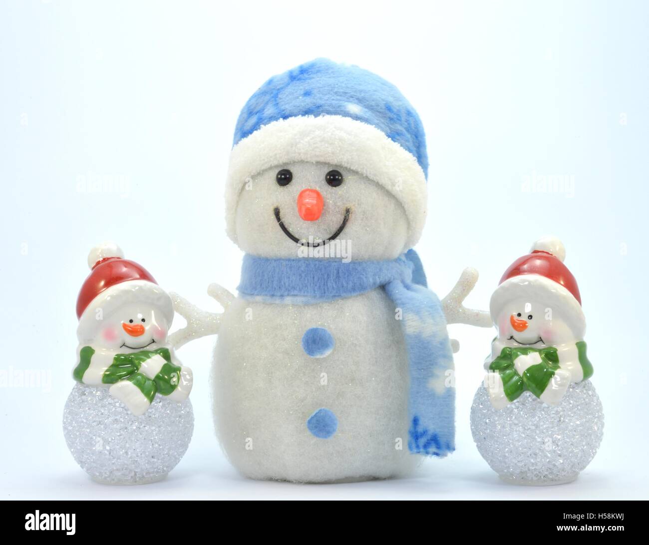 Trio of snowman with a glass ball Stock Photo - Alamy
