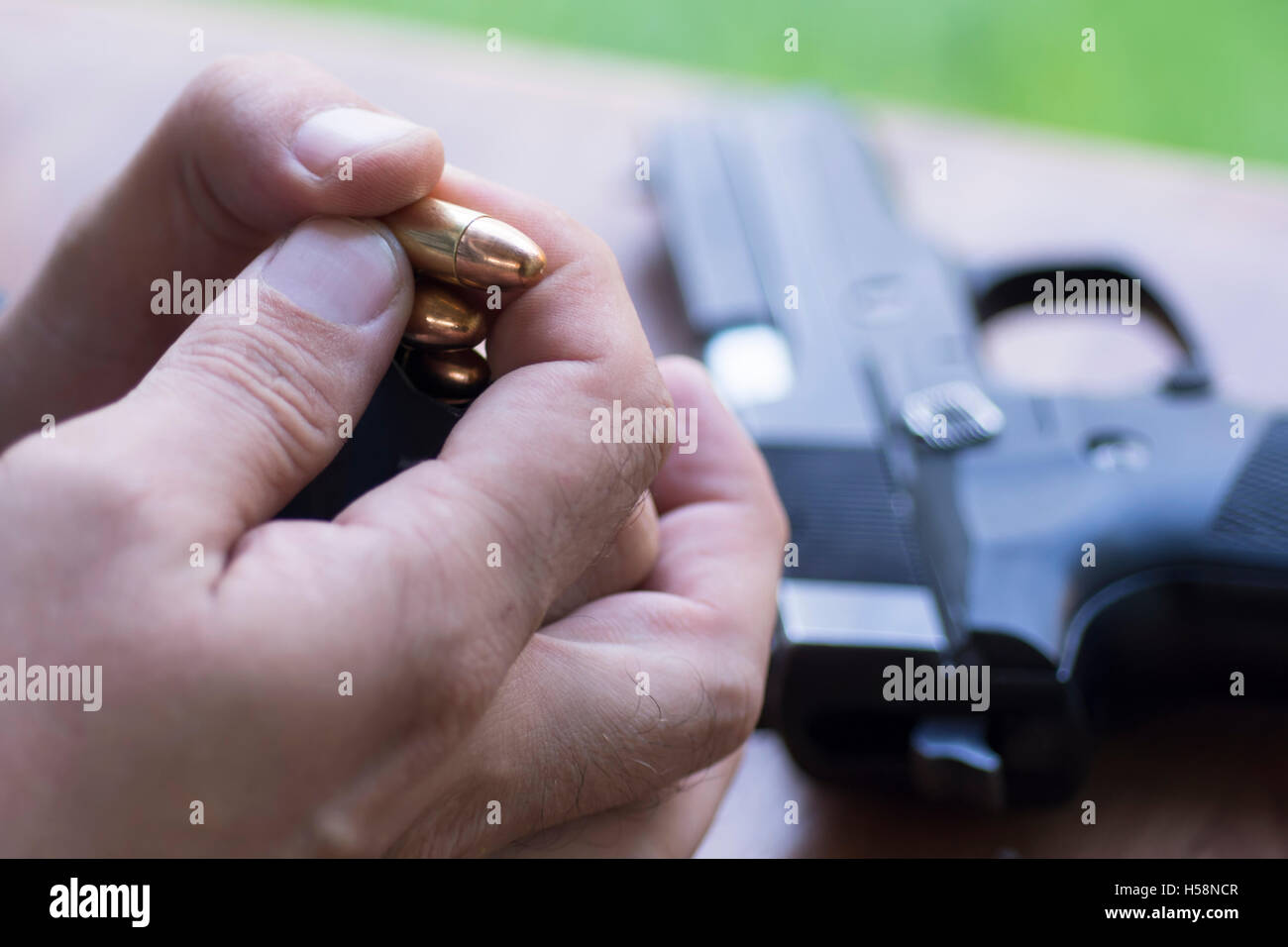 Loading Handgun Magazine. Bullets and Pistol Background. Charging Gun ...
