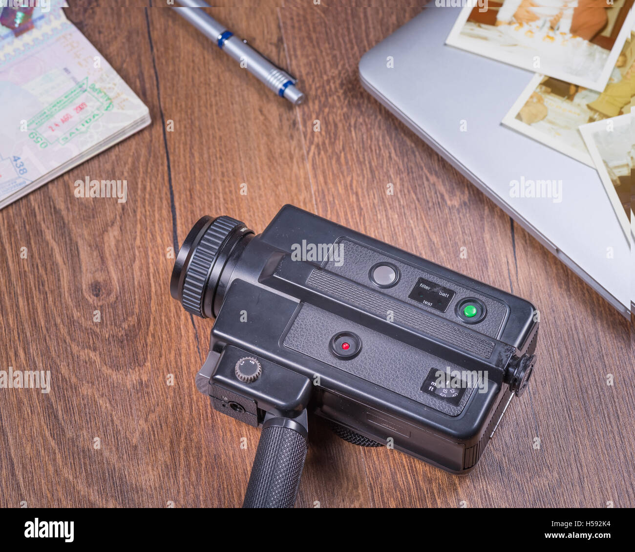 Vintage image with old black Video camera 8mm,old photo,laptop,pen and ...