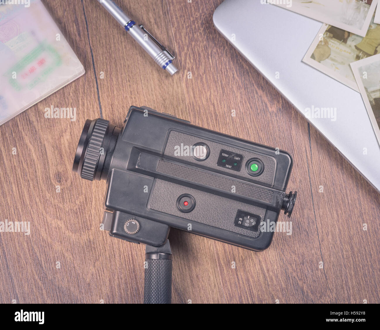 Vintage image with old black Video camera 8mm,old photo,laptop,pen and ...