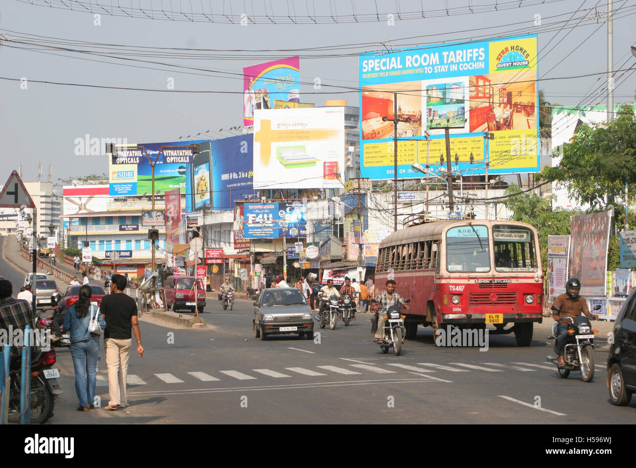 A busy urban road on the outskirts of Kochi, southern India. Shows bill ...
