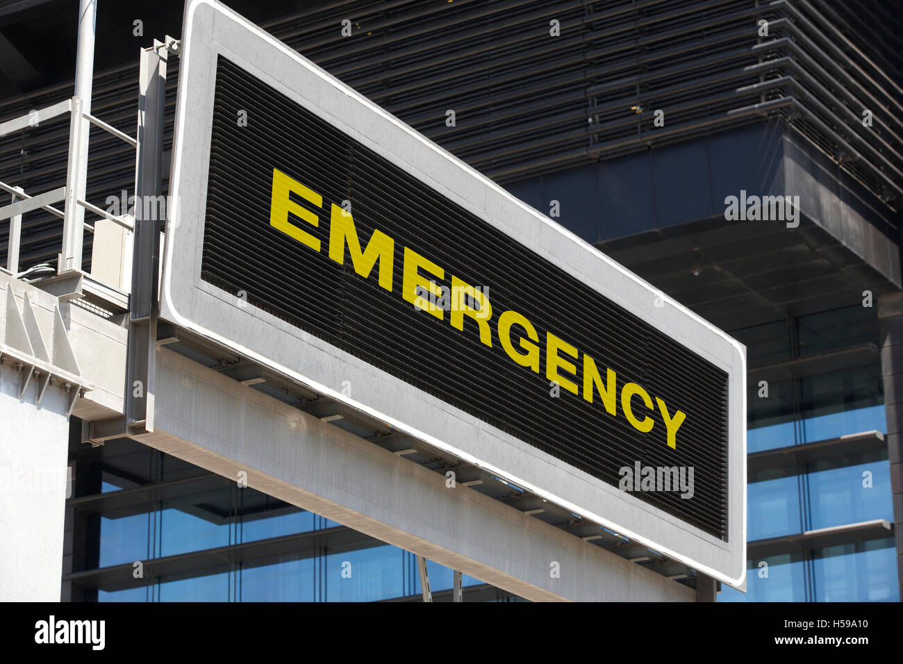 Emergency traffic signpost in the city with building facade background ...