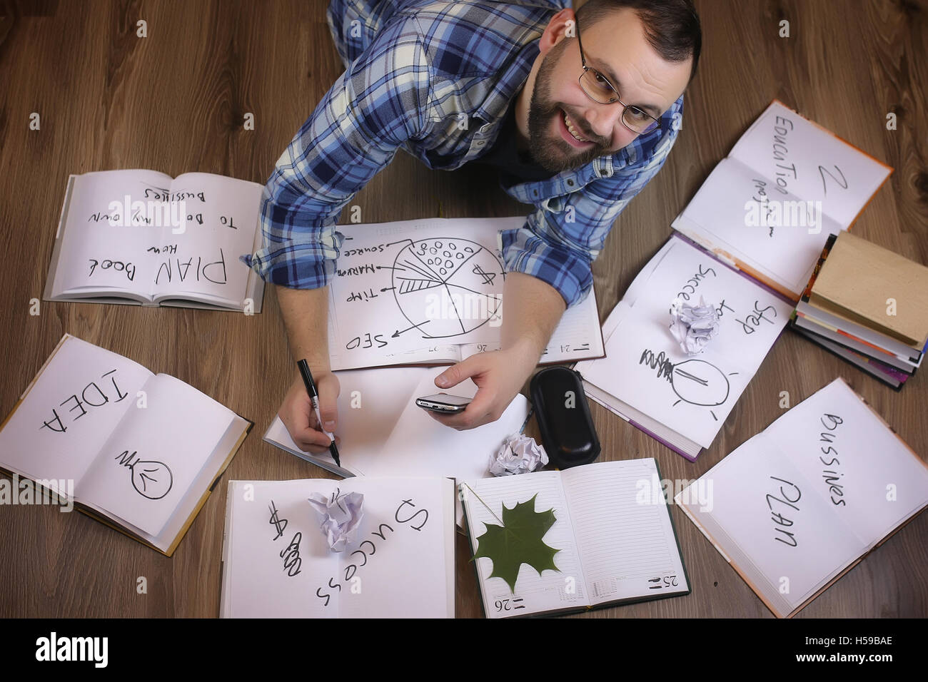 man working with book on the floor Stock Photo - Alamy