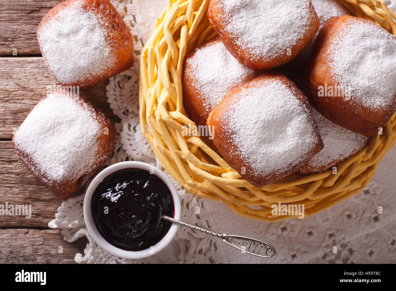 New Orleans beignets donuts in a basket and jam closeup. horizontal top ...