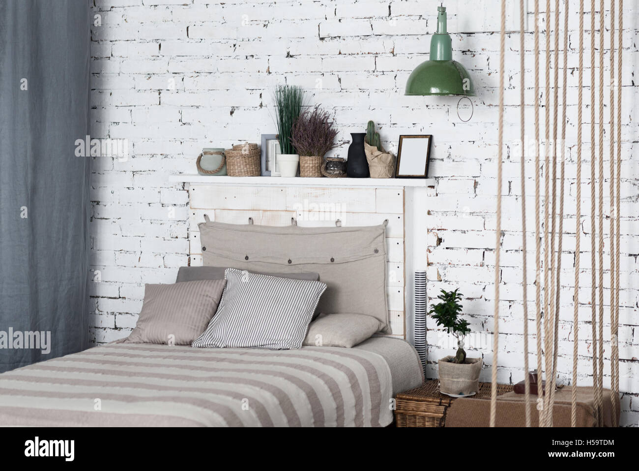 Modern bedroom with big grey bed in middle Stock Photo - Alamy