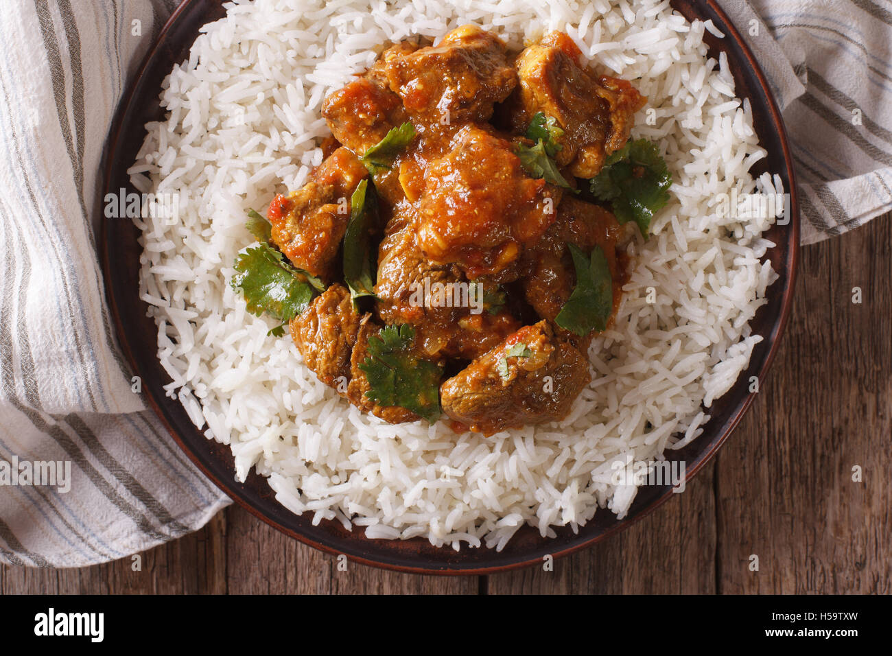 Traditional beef madras with basmati rice close-up on a plate ...
