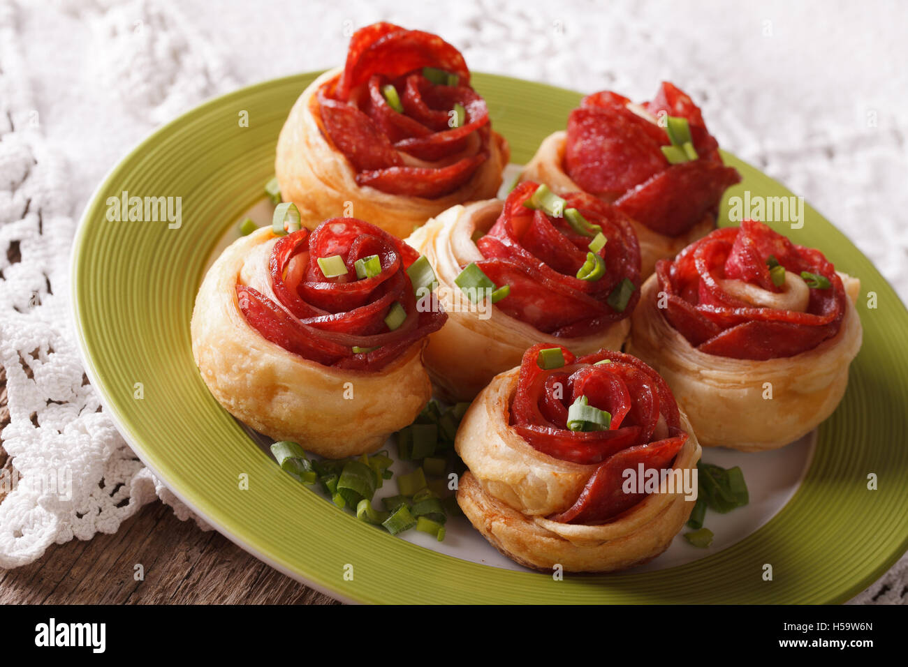 Beautiful hot sandwiches with salami in the form of a flower on a plate ...