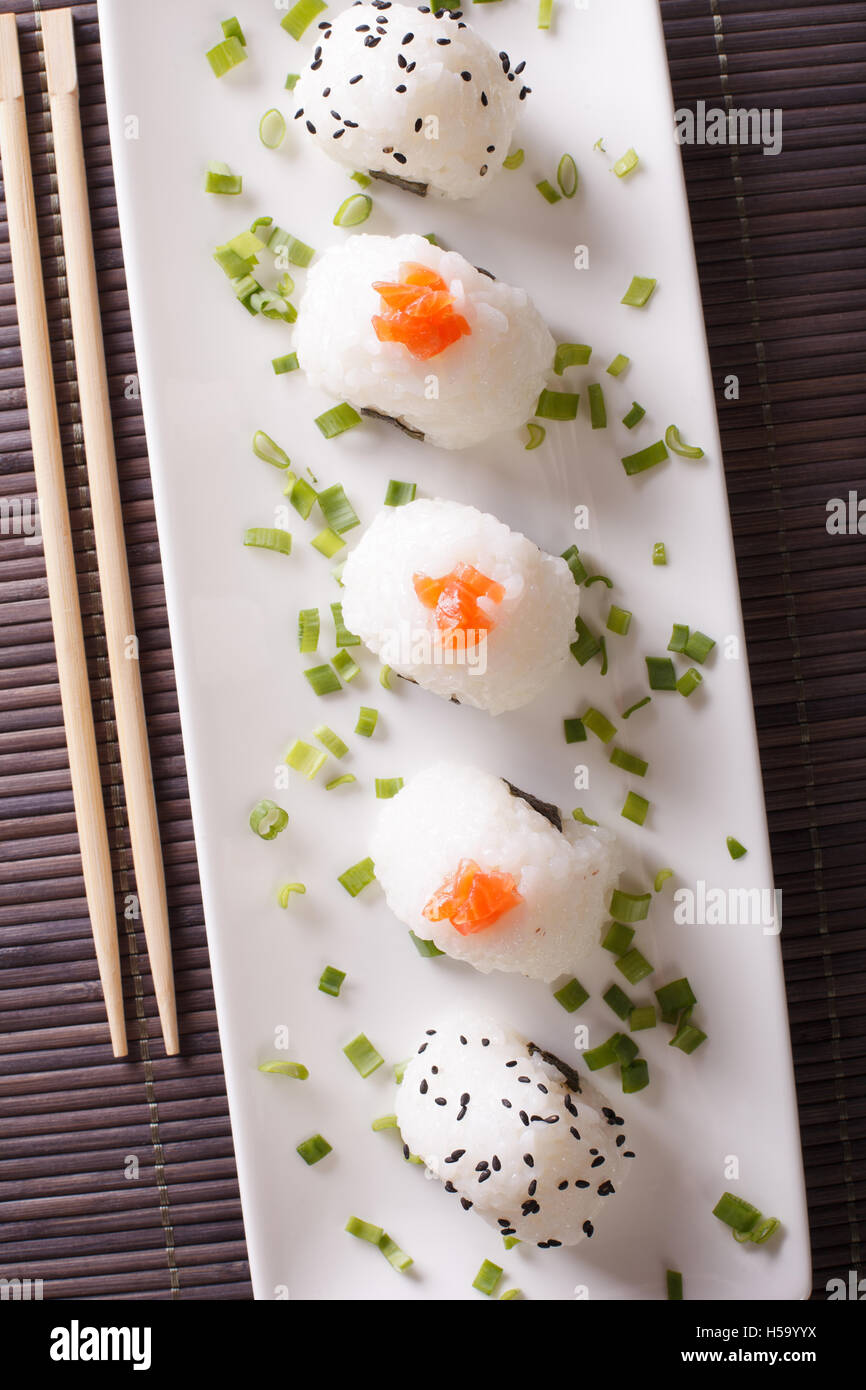Japanese onigiri rice balls stuffed with salmon and sesame close-up on ...