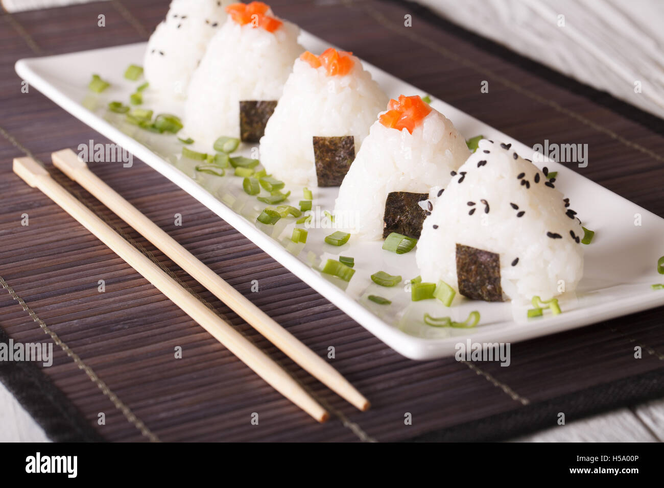 Japanese onigiri rice balls stuffed with salmon and sesame close-up on ...