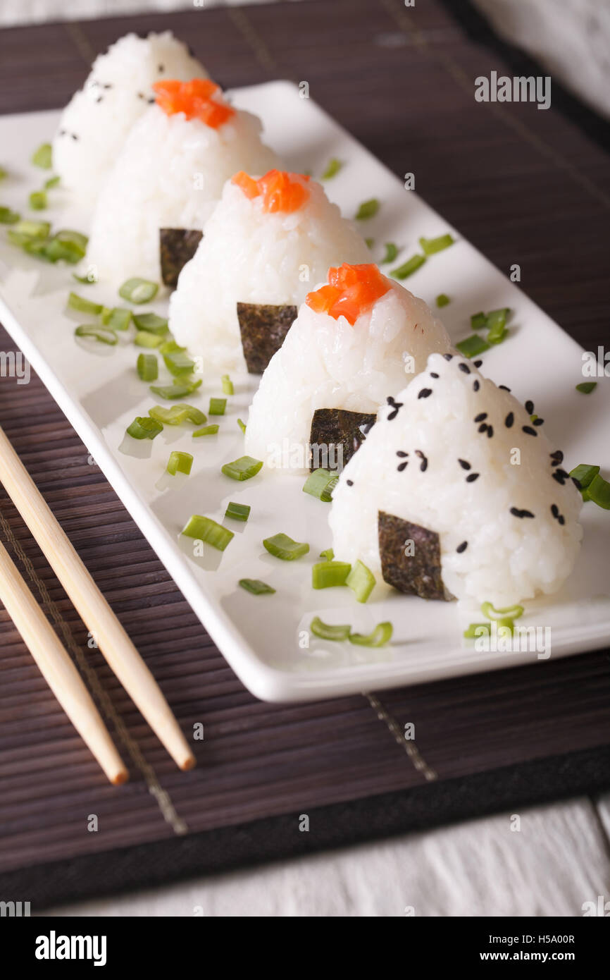 Japanese onigiri rice balls stuffed with salmon and sesame close-up on ...