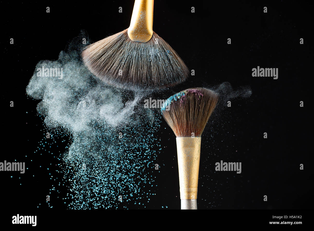 Thick professional brush and loose powder particles scattered around ...