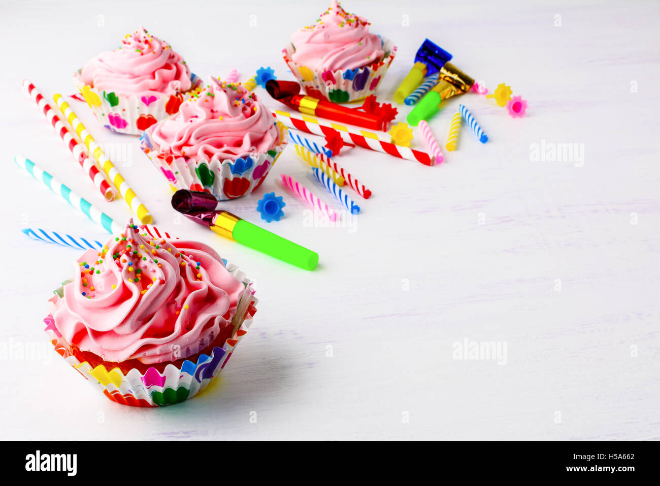 Birthday party background with decorated pink cupcakes and candles ...