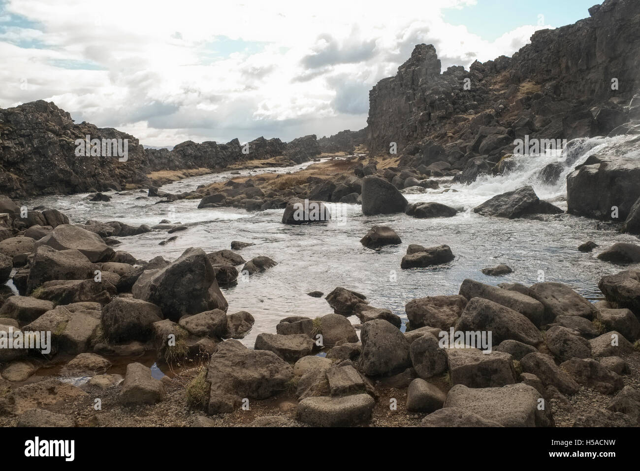 Large rocks and stream flowing between Stock Photo - Alamy