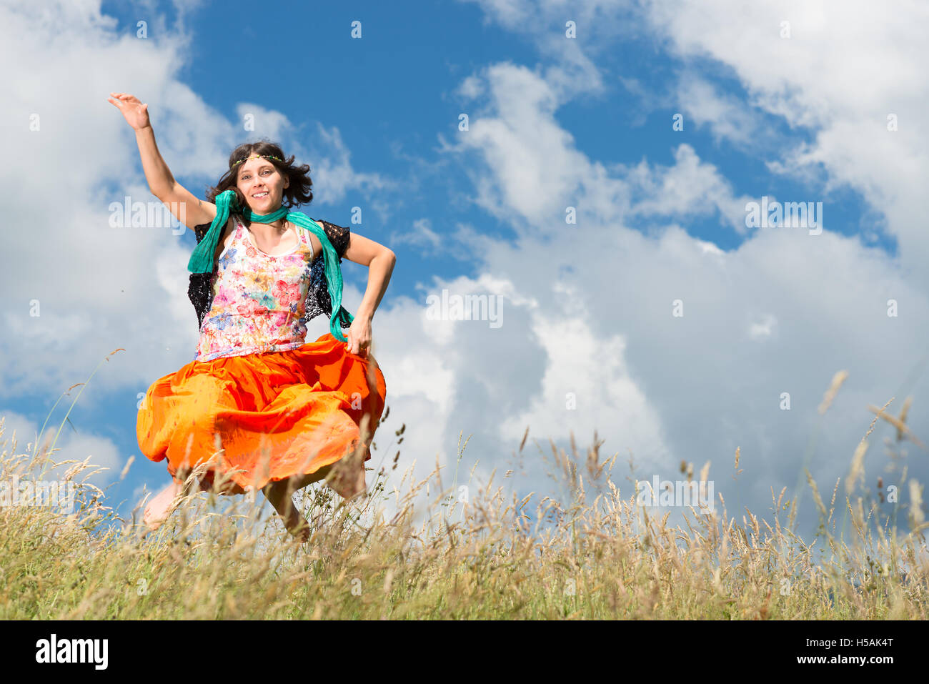 Woman hippie jumping in meadow Stock Photo - Alamy