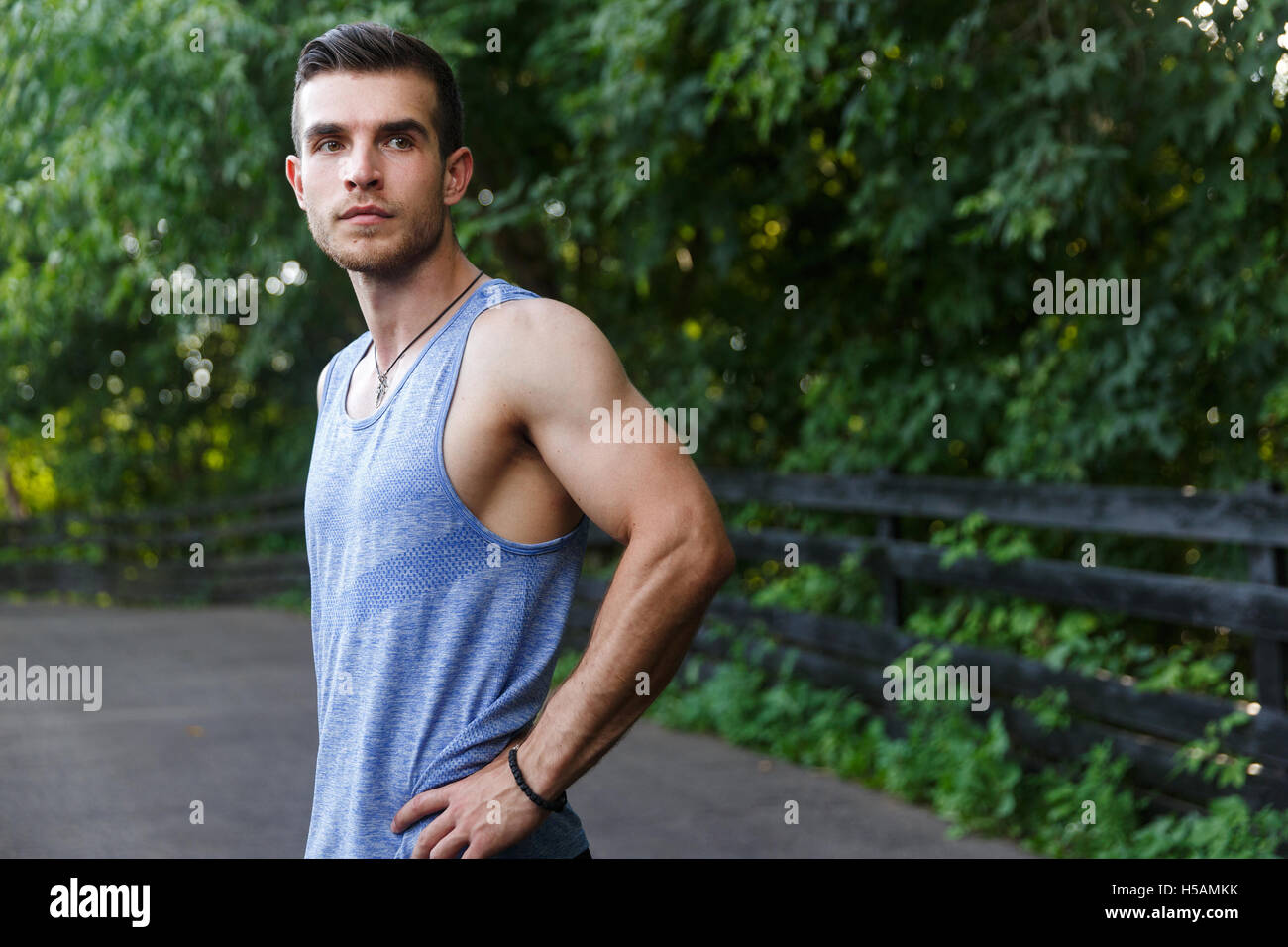 Young sportsman standing on track in park Stock Photo - Alamy