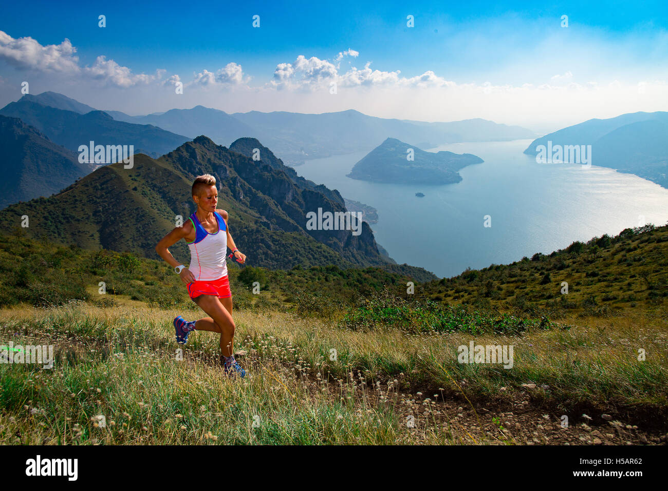 Woman trail running athlete trains in the mountains with fantastic ...