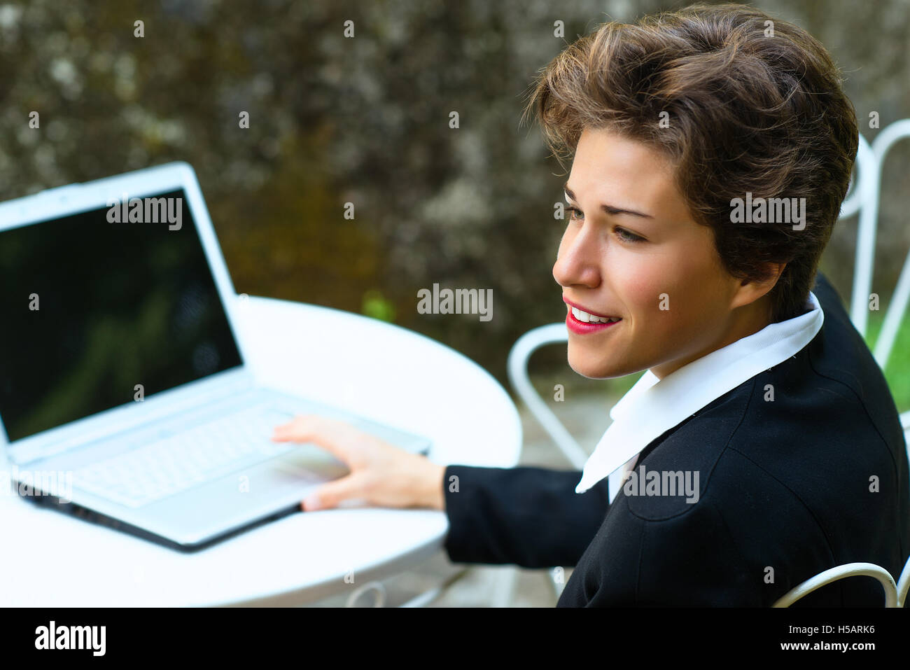 Woman working at the computer in the garden Stock Photo - Alamy