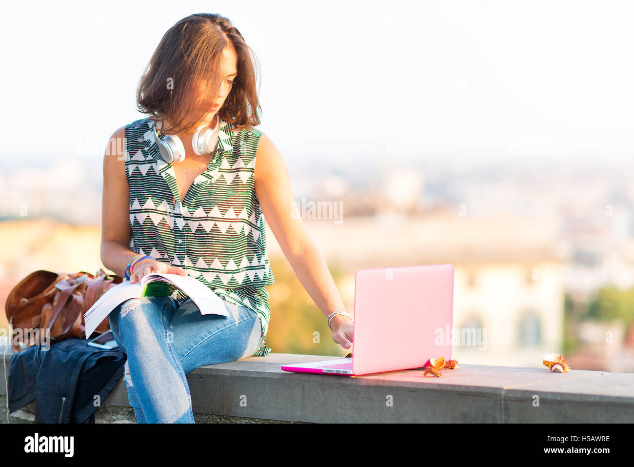 Young beautiful girl student studying for an exam with books and ...