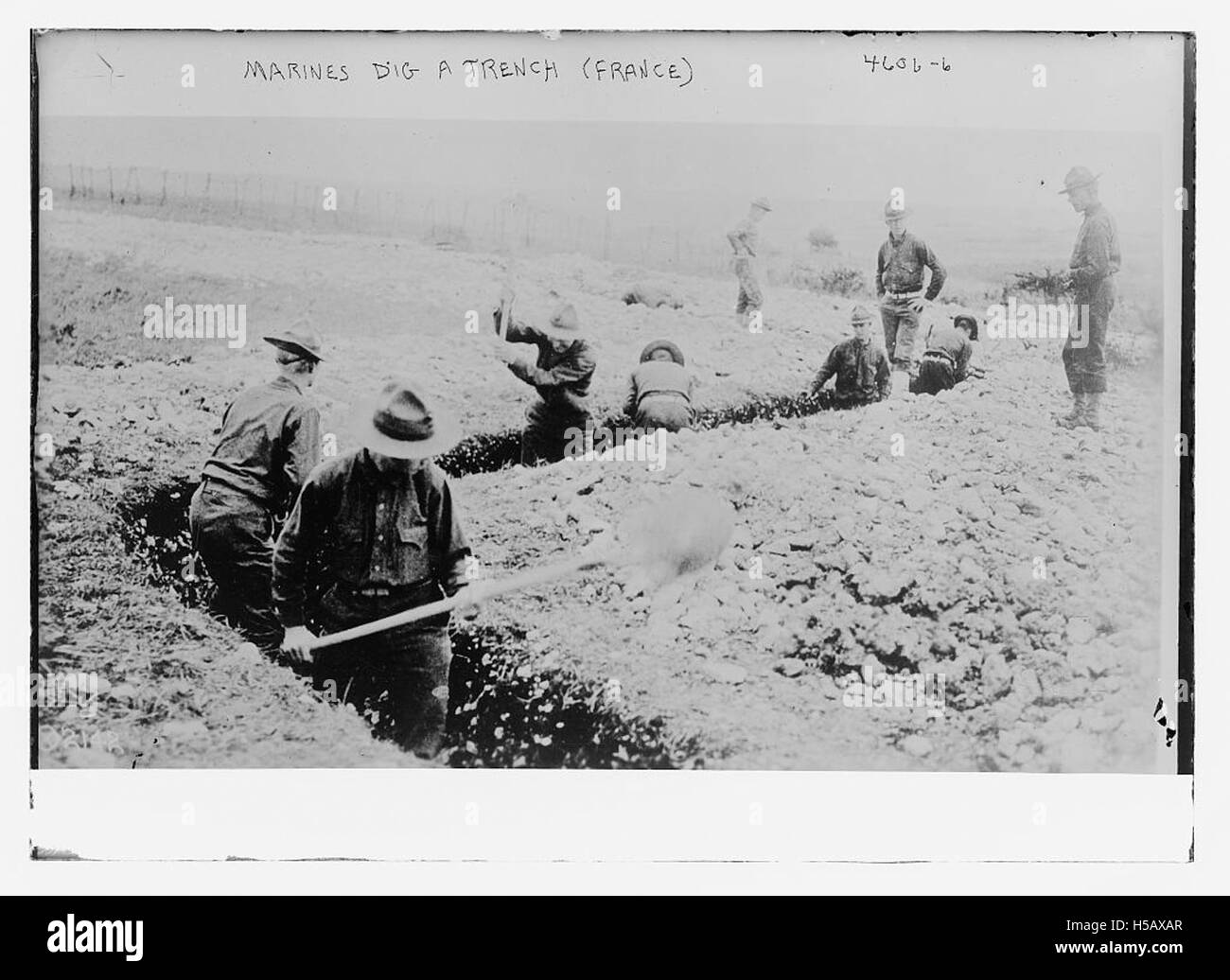 This photograph shows Marines digging a trench, possibly during a ...