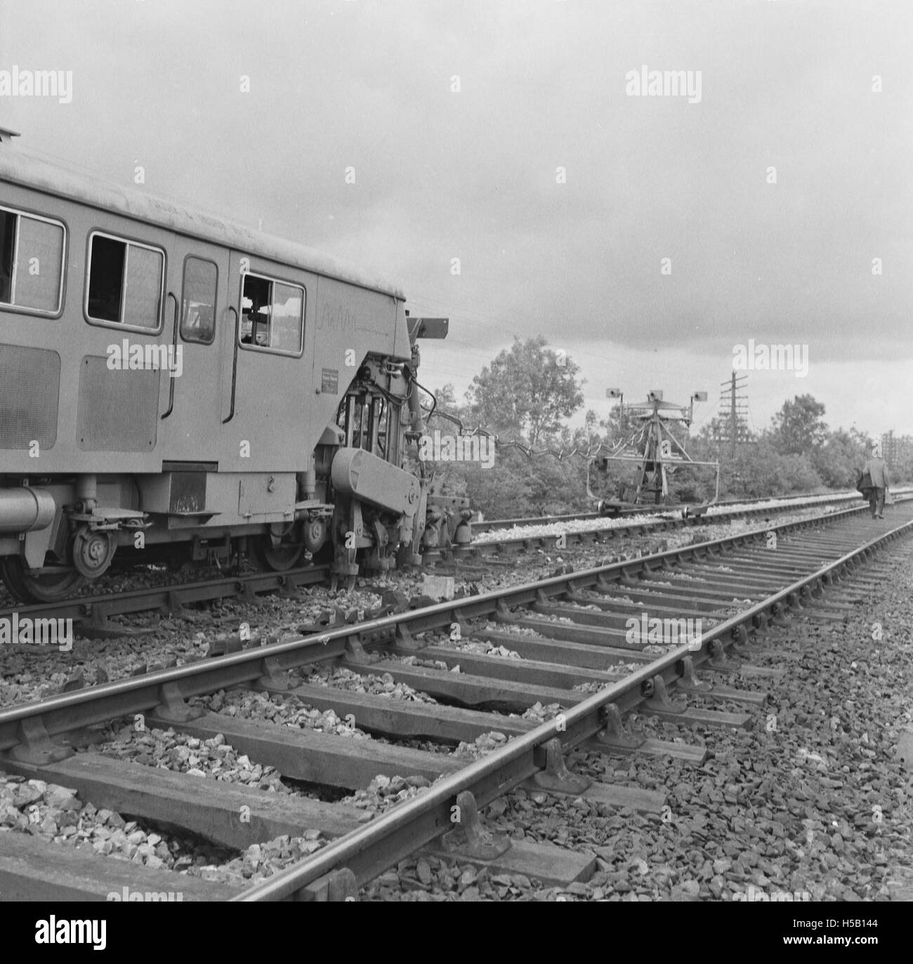 This image features a tamping machine, a piece of railway equipment ...