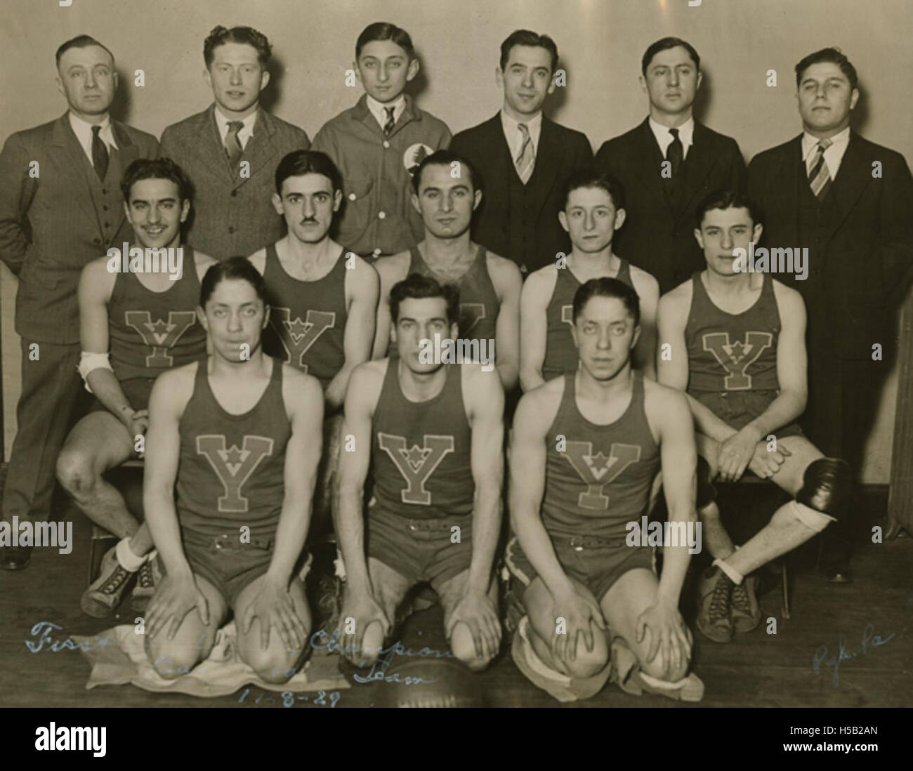 The photograph captures the Y.M.H.A. basketball team on November 8 ...