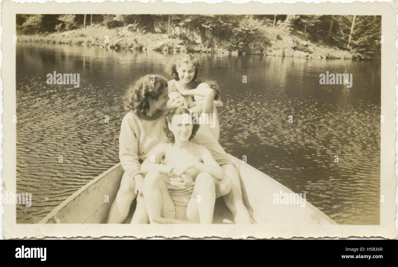 Teenagers in a rowboat at summer camp Stock Photo - Alamy