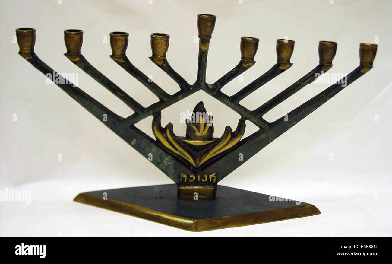 A traditional Hanukkah lamp, also known as a menorah, made of brass ...
