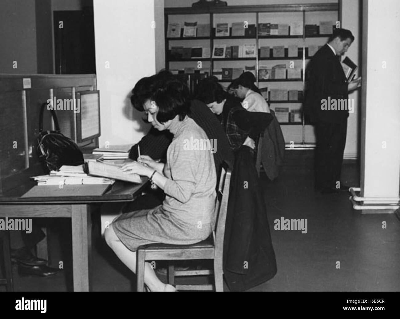 This photograph shows a library in 1964, likely representing a public ...