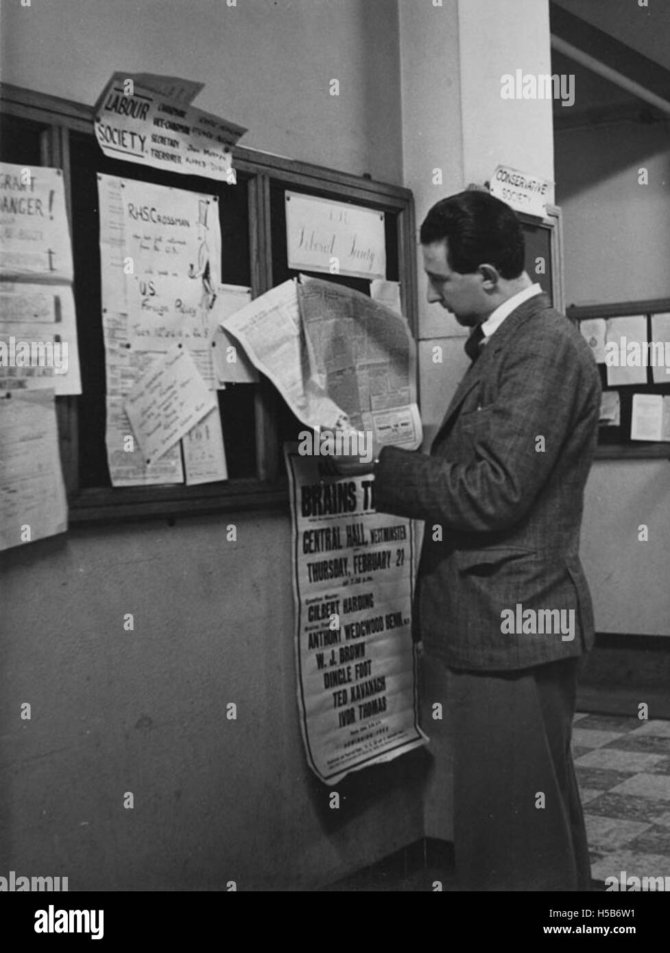 Student reading a newspaper at the notice boards, c1950s Stock Photo ...