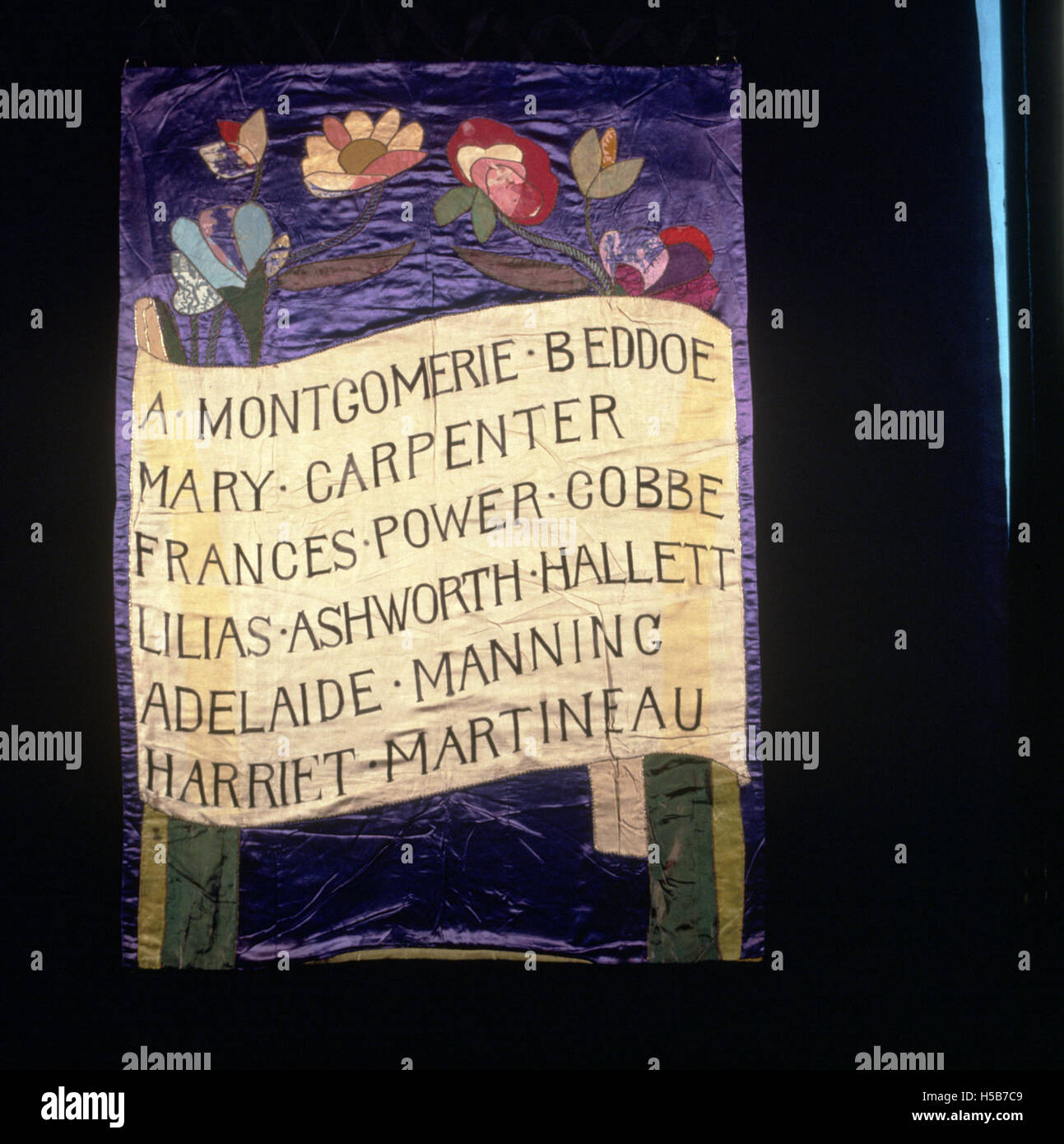 This historical image shows a suffrage banner, likely from the early ...