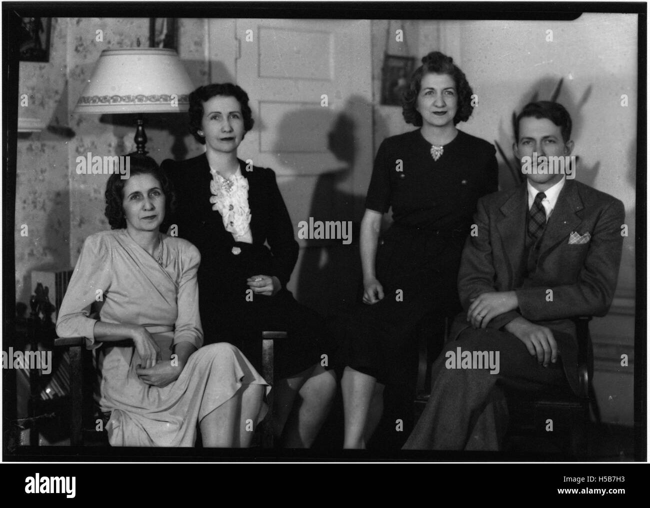 A photograph depicting three women and one man, with their identities ...