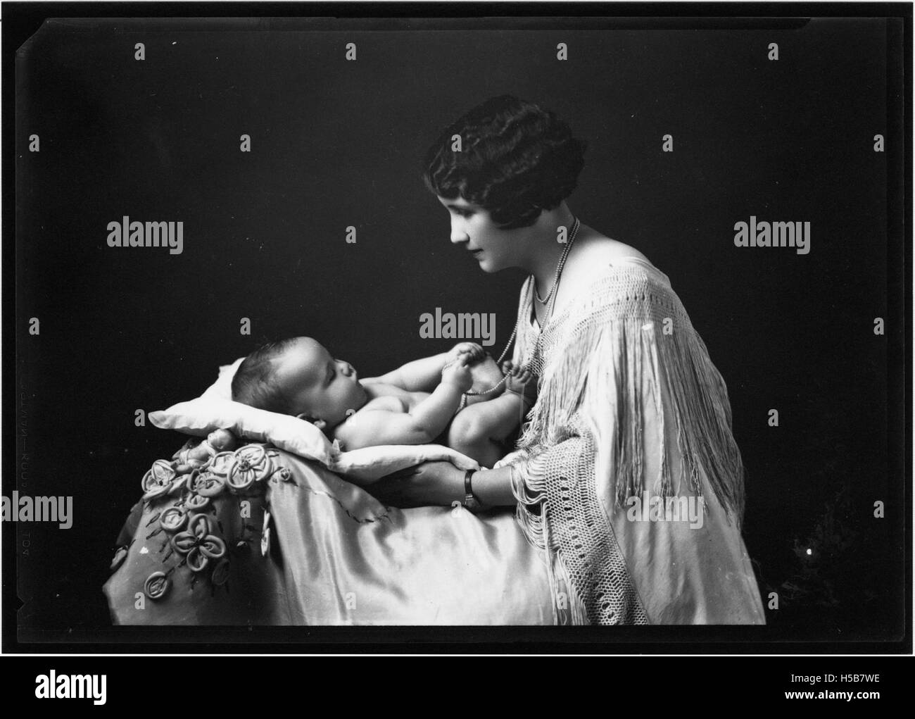 A photograph showing an unidentified woman and an infant, capturing a ...
