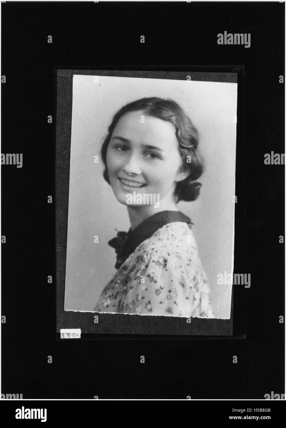 This portrait photograph captures an unidentified woman, offering ...
