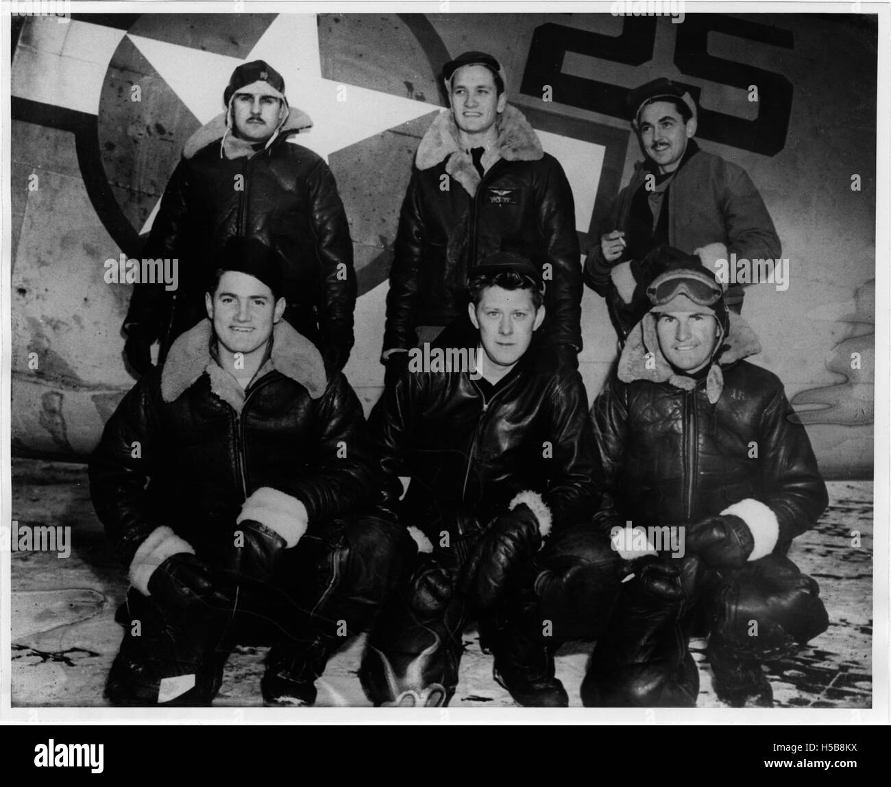 This image features a flight crew, likely from an early aviation period ...