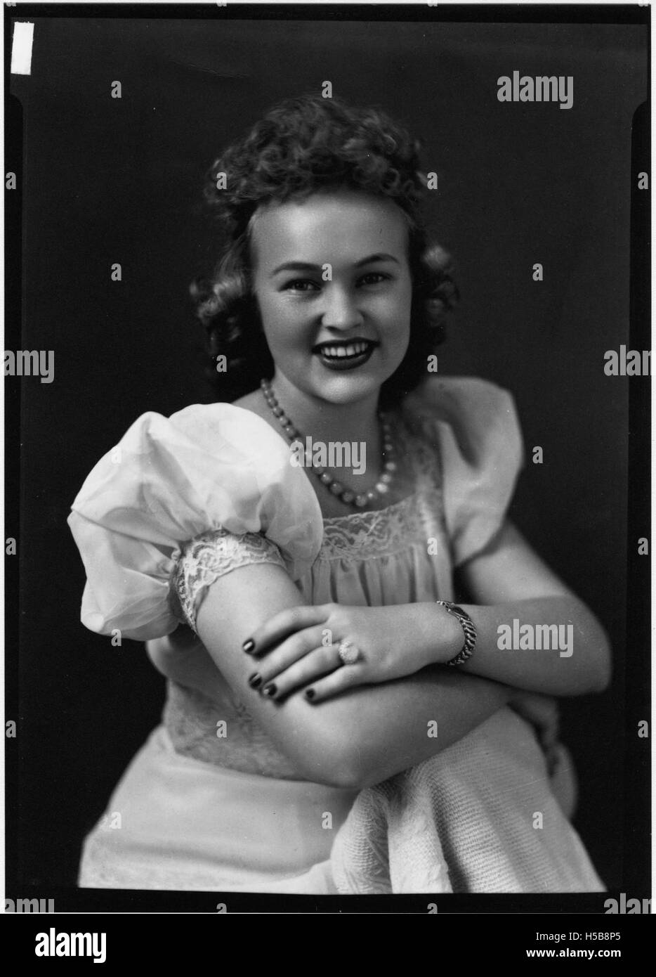 This portrait features an unidentified woman, showcasing her attire and ...
