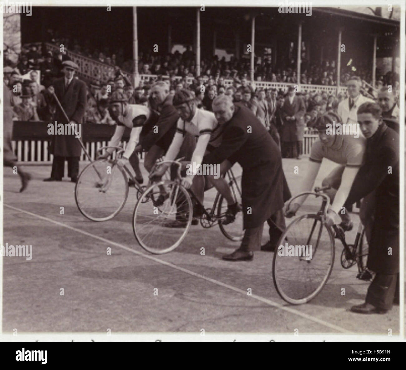 This image captures the start of a cycle race in 1937, showing ...
