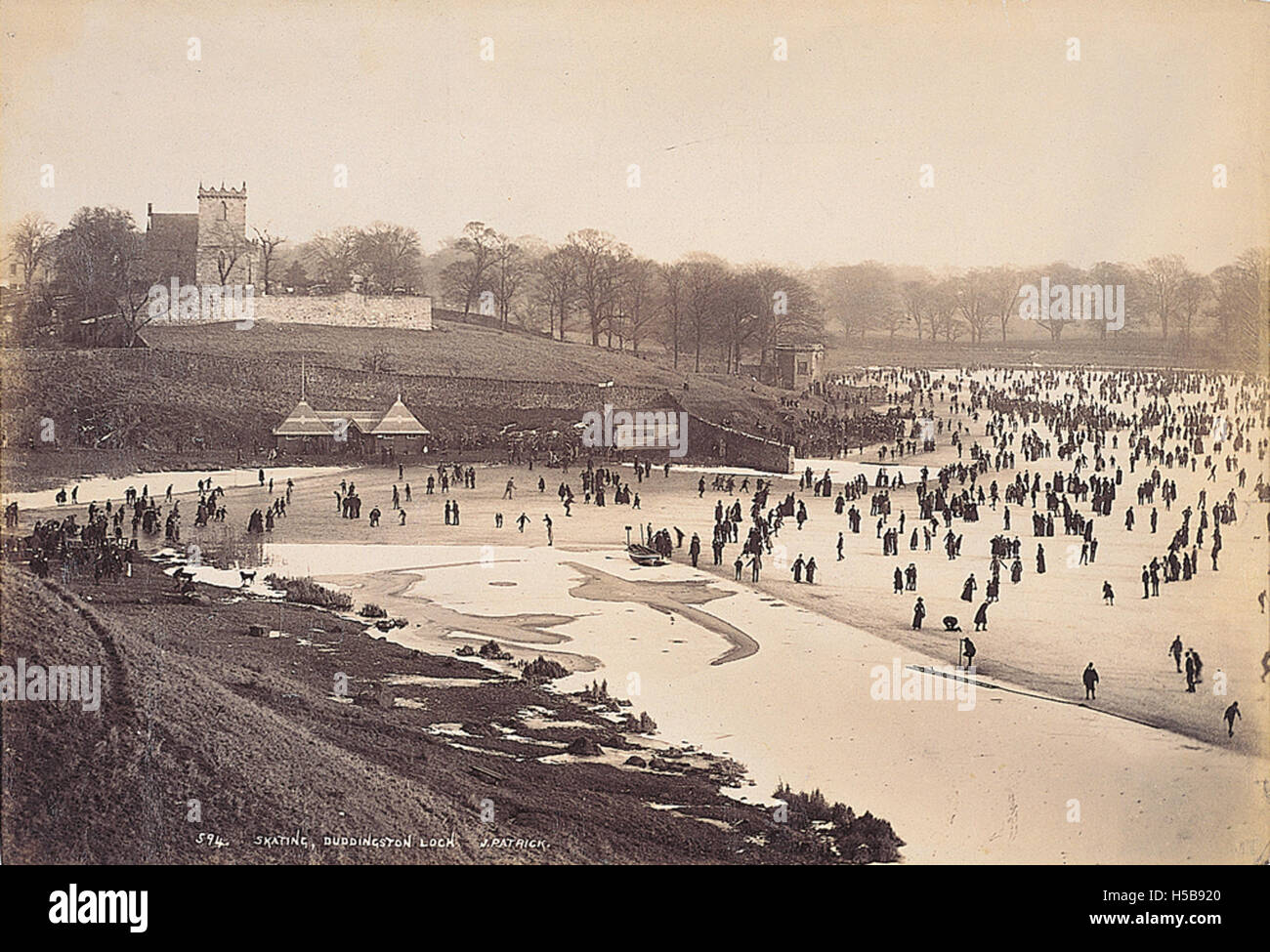 This photograph shows people skating on Duddingstone Loch, capturing a ...