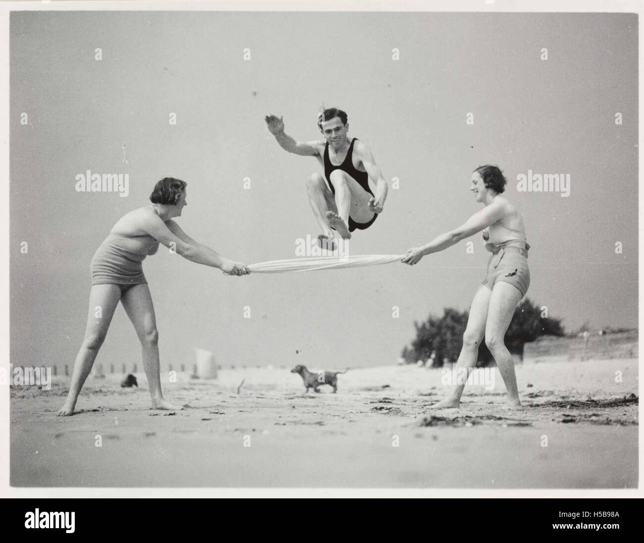 This image captures individuals exercising on a beach, showcasing a ...