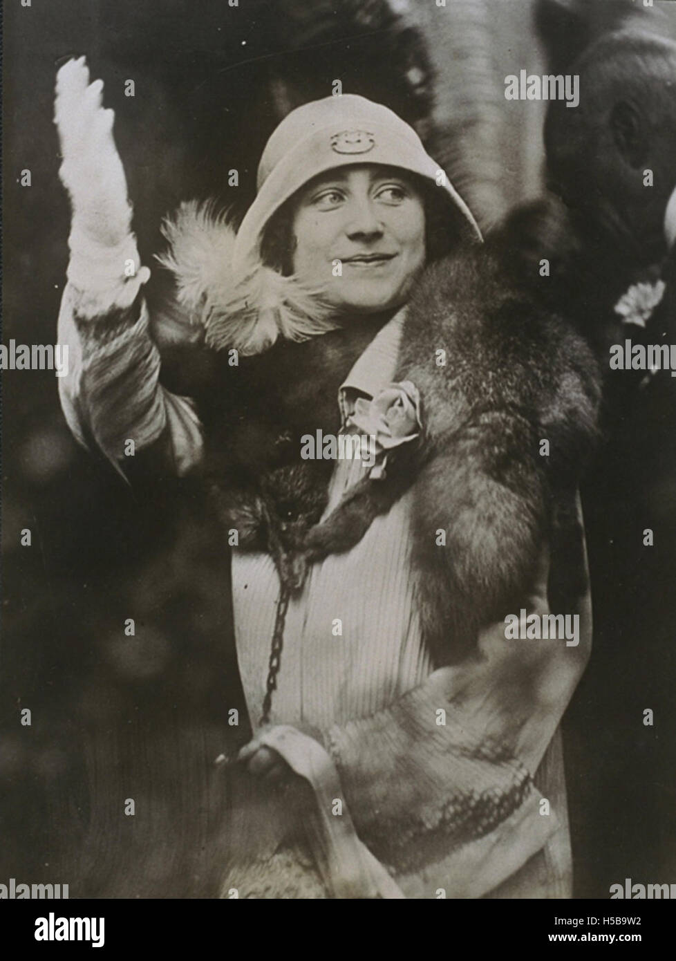 This photograph captures a moment of the Queen waving to crowds during ...