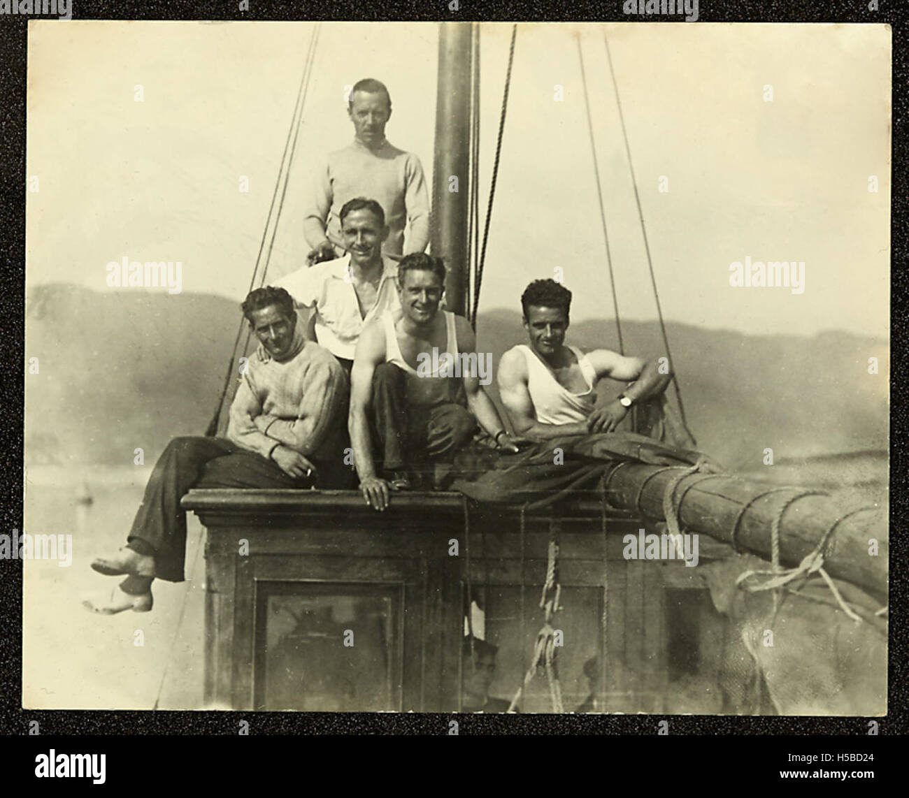 A photograph of five men posing together, likely for a formal or social ...