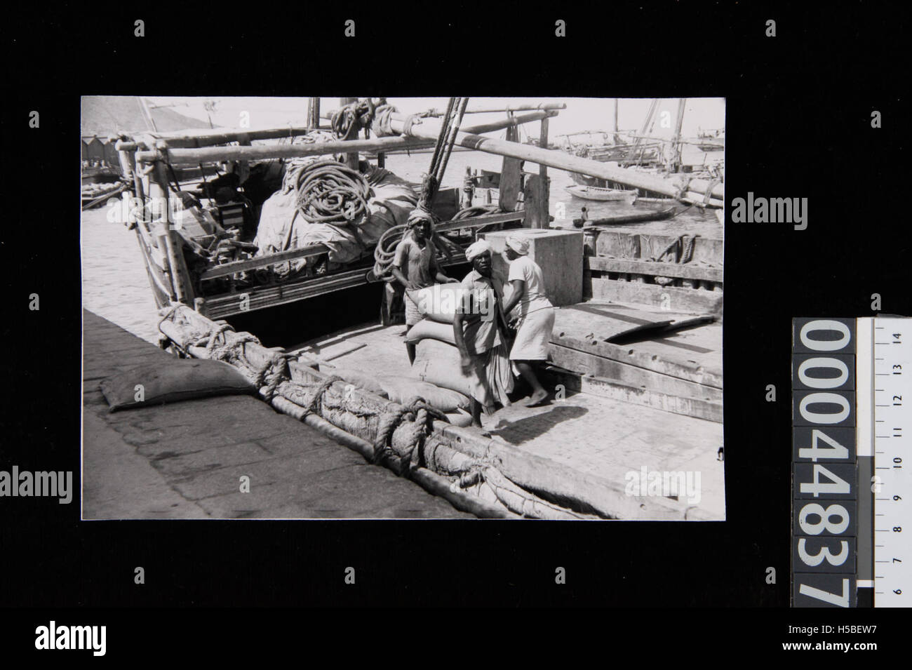 A photograph of a crew aboard a large dhow in Ma'alla, Aden, Yemen. The ...