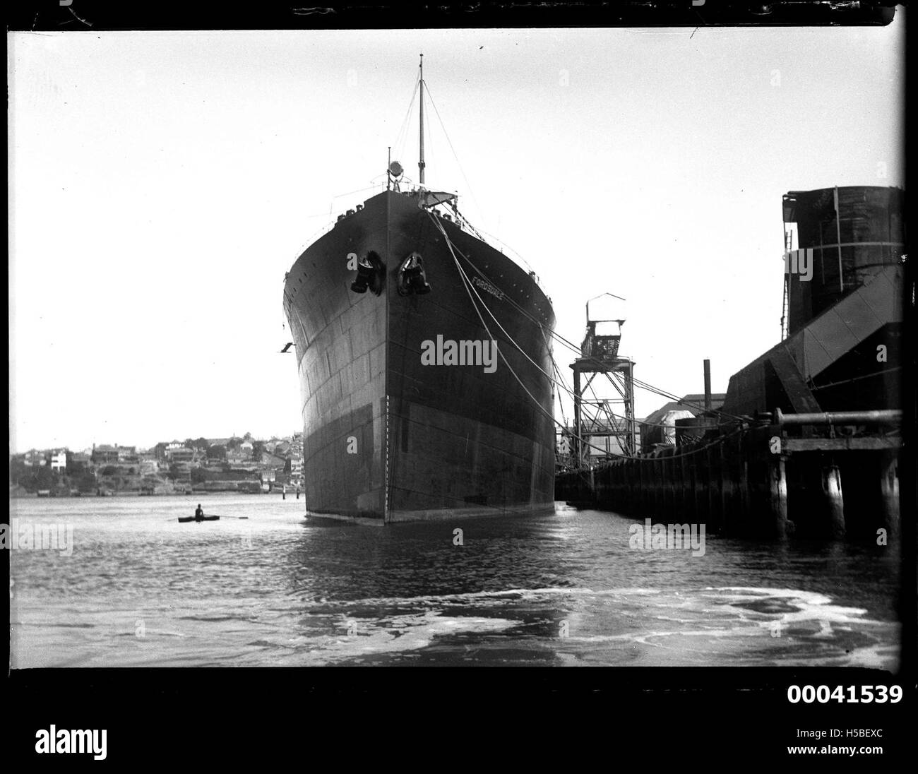 This image depicts the FORDSDALE ship at Cockatoo Island, with a man in ...