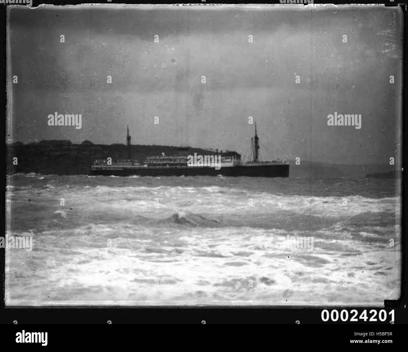 This photograph captures the MV Manunda, a passenger ship, docked in ...
