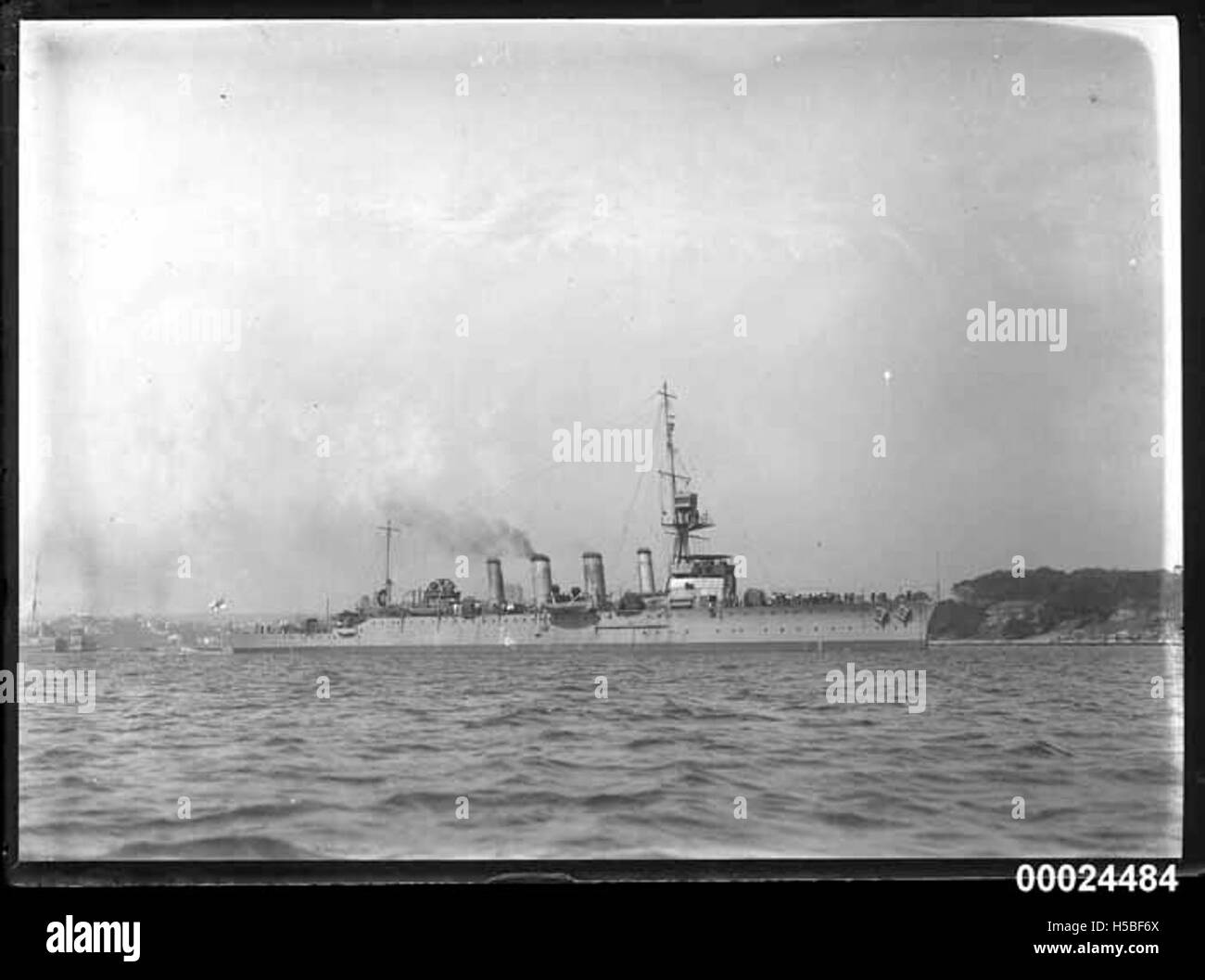 A light cruiser, likely the HMAS Adelaide, is shown in service with the ...
